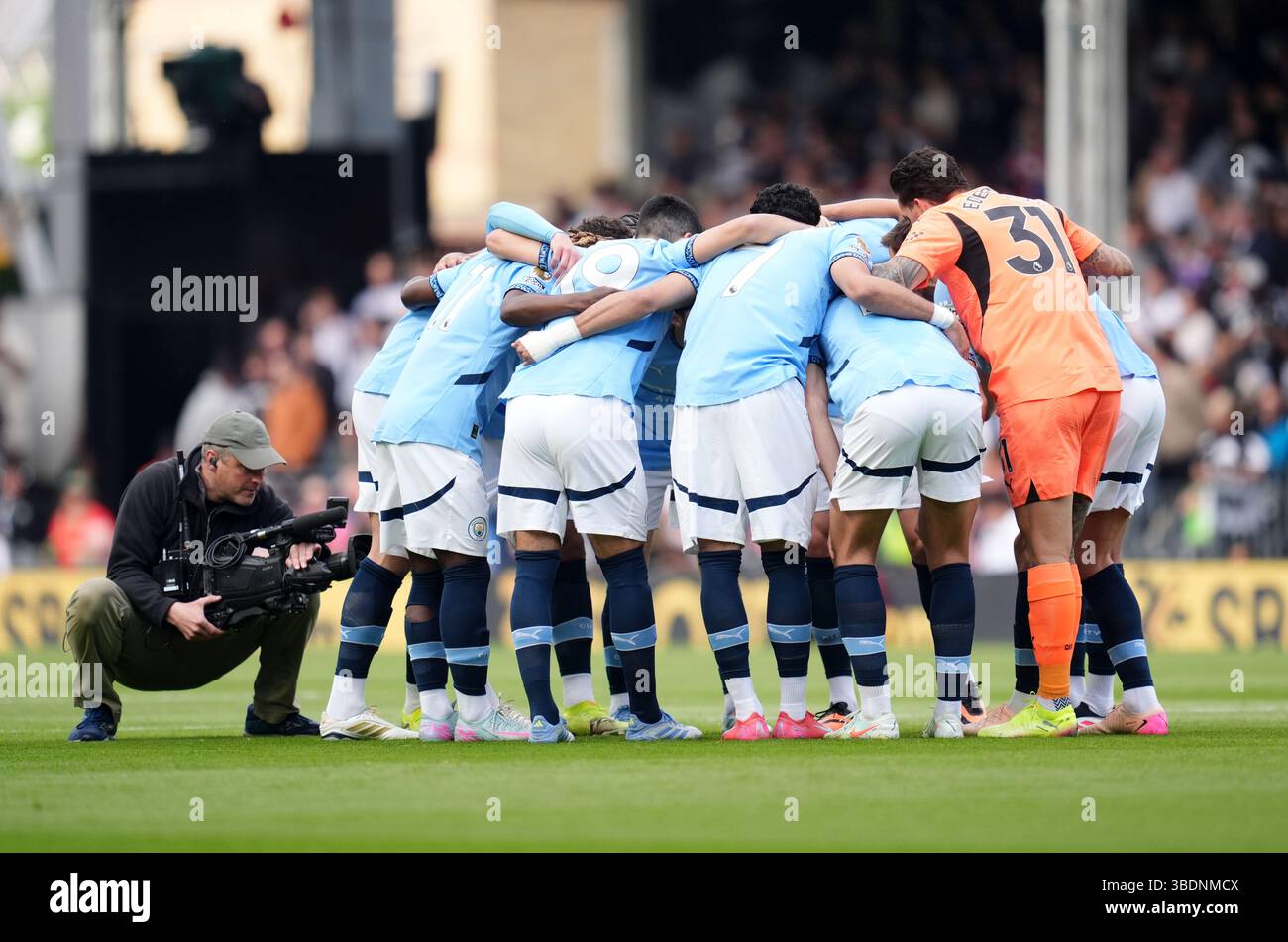 Manchester City players huddle before the Premier League match at ...