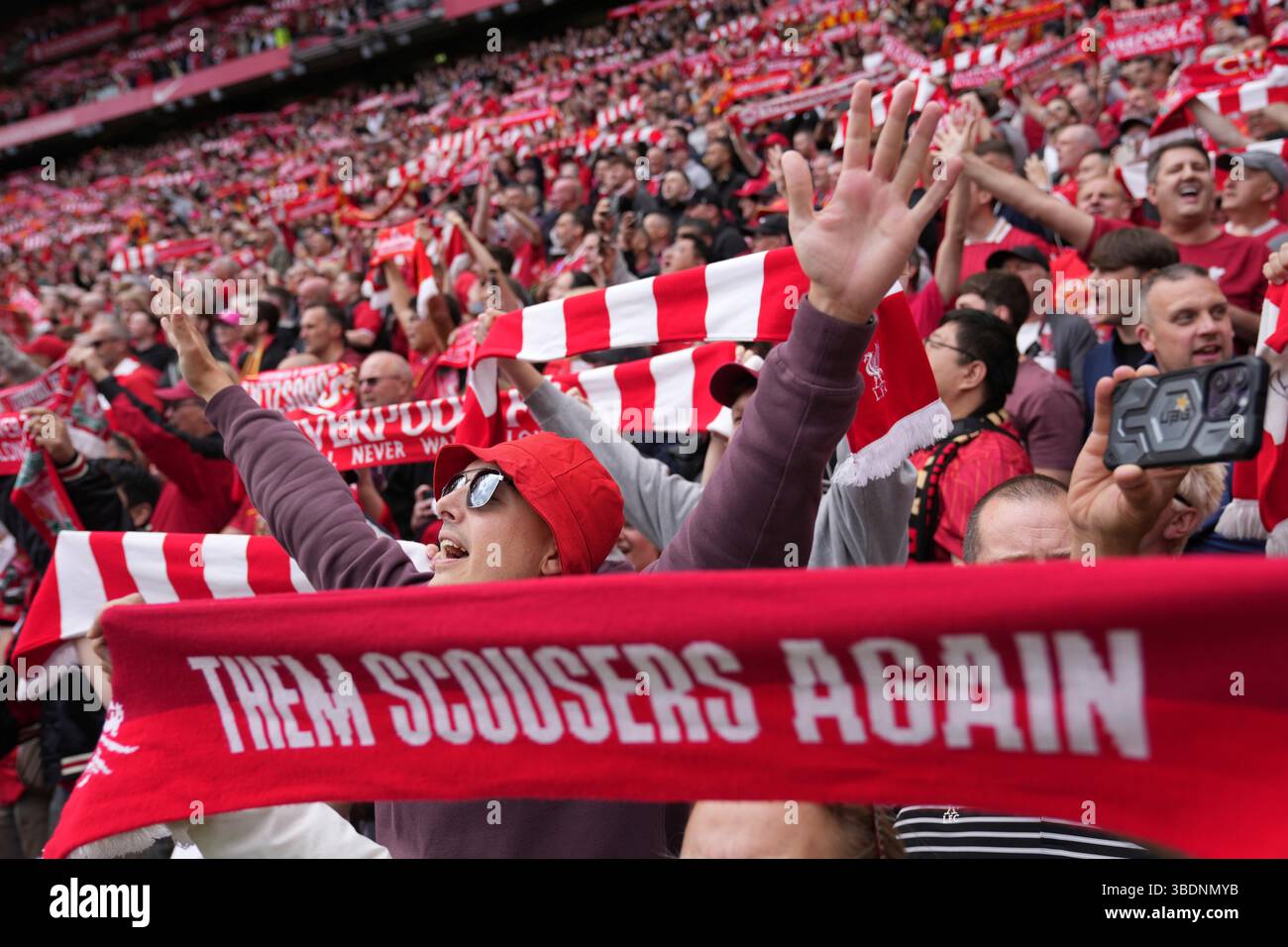 Liverpool fans cheer for their team before the start of the English ...