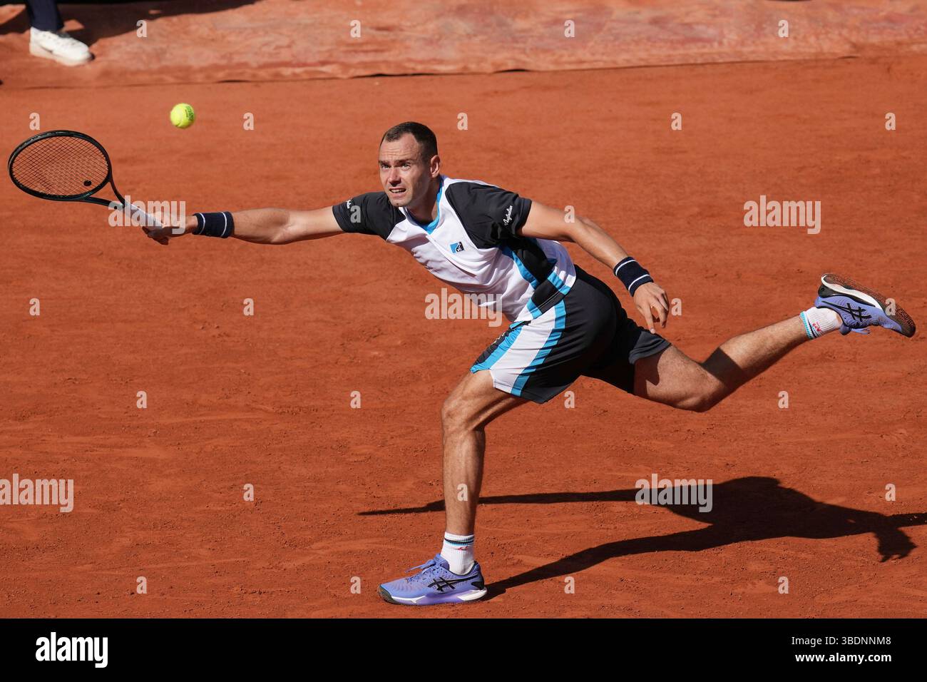 Russia's Roman Safiullin returns the ball to Frances Tiafoe of the U.S ...