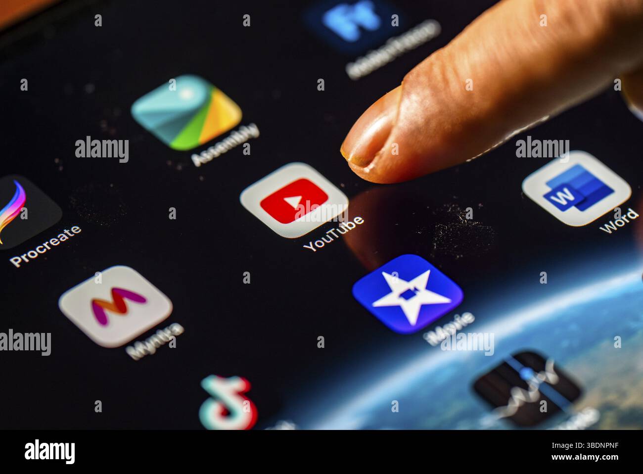 In this photo Illustration a person taps Googles Youtube application on ...