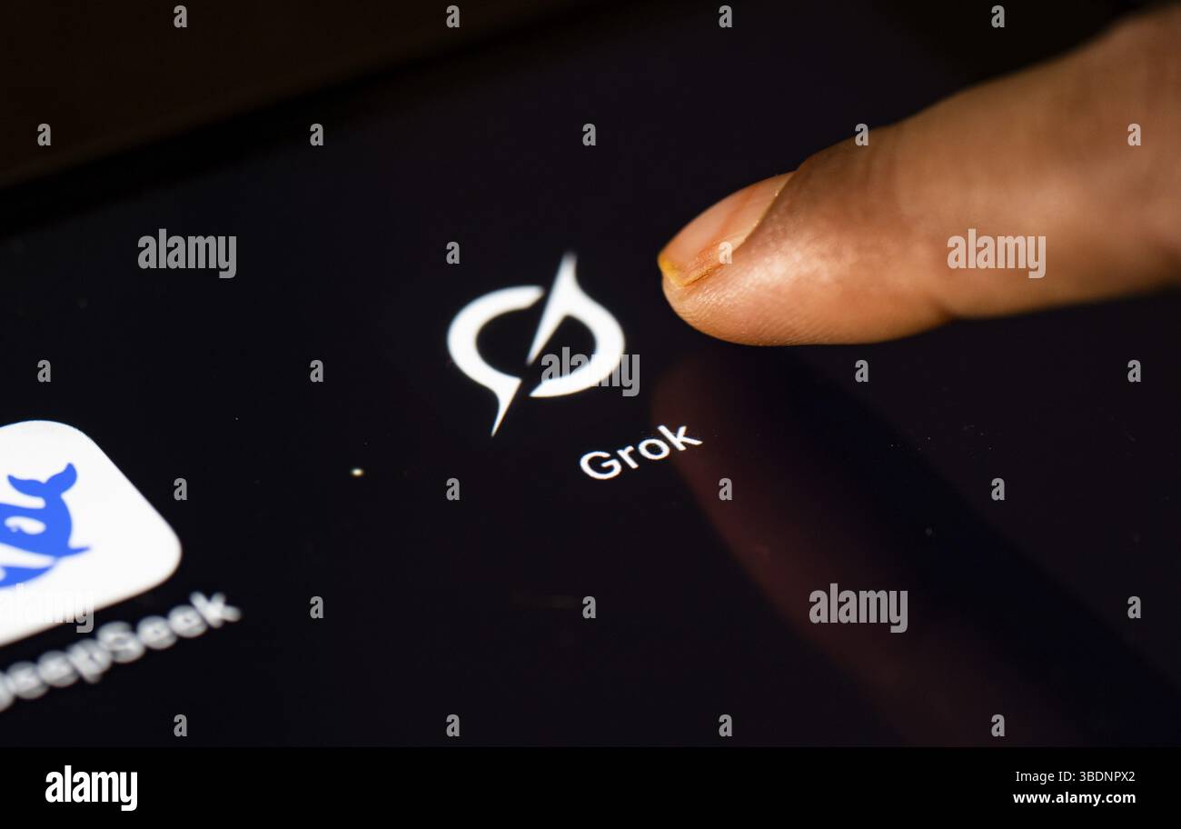 In this photo Illustration a person taps Grok AI application icon on a ...