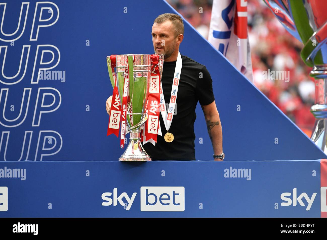 London, England. 25th May 2025. Nathan Jones celebrates with the trophy ...