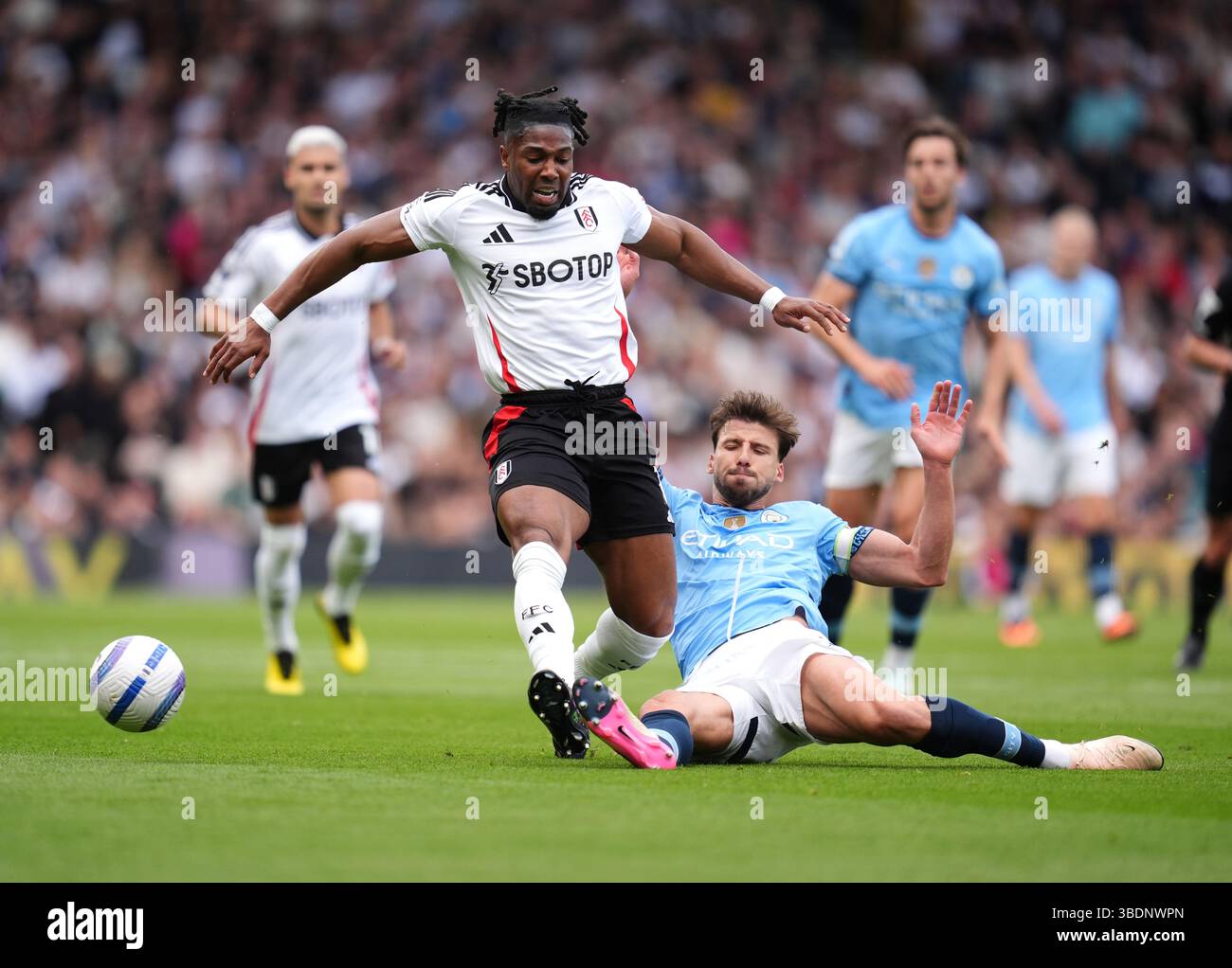 Fulham's Adama Traore and Manchester City's Ruben Dias (right) battle ...
