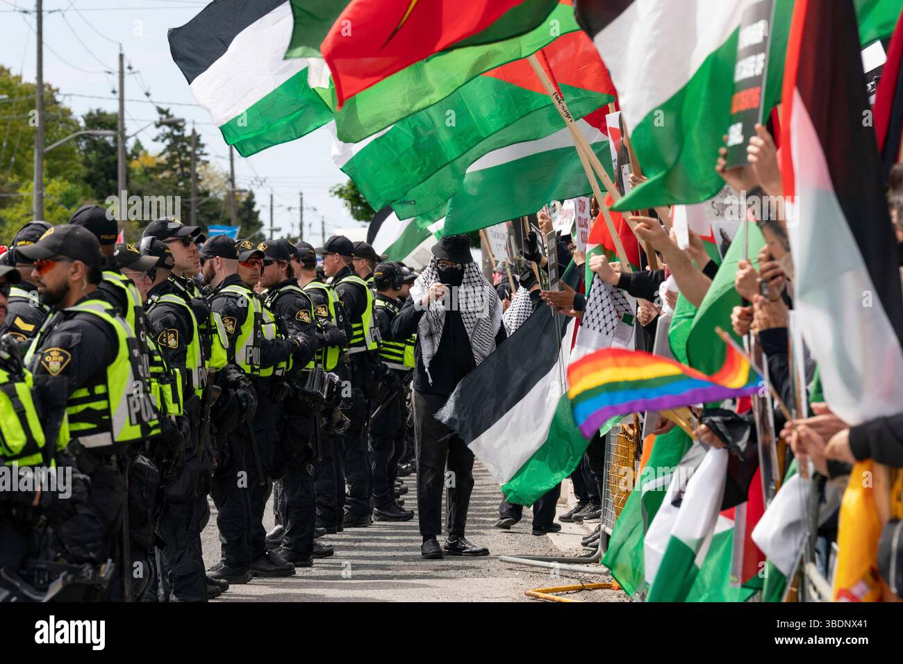 Pro-Palestinian protesters gather along the route of the United Jewish ...