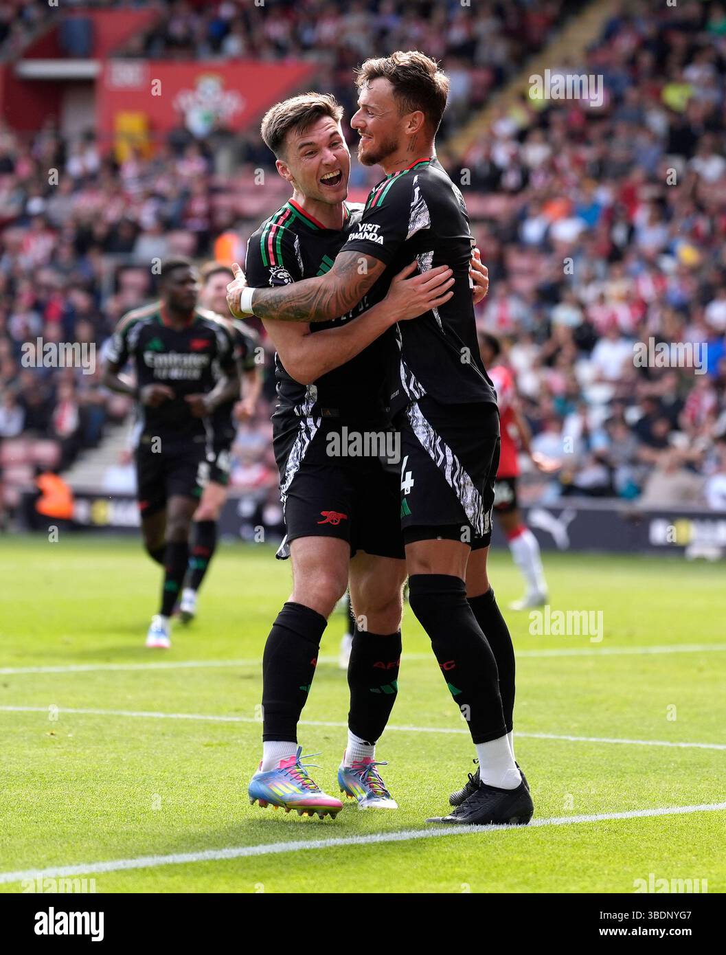 Arsenal's Kieran Tierney (left) celebrates scoring their side's first ...