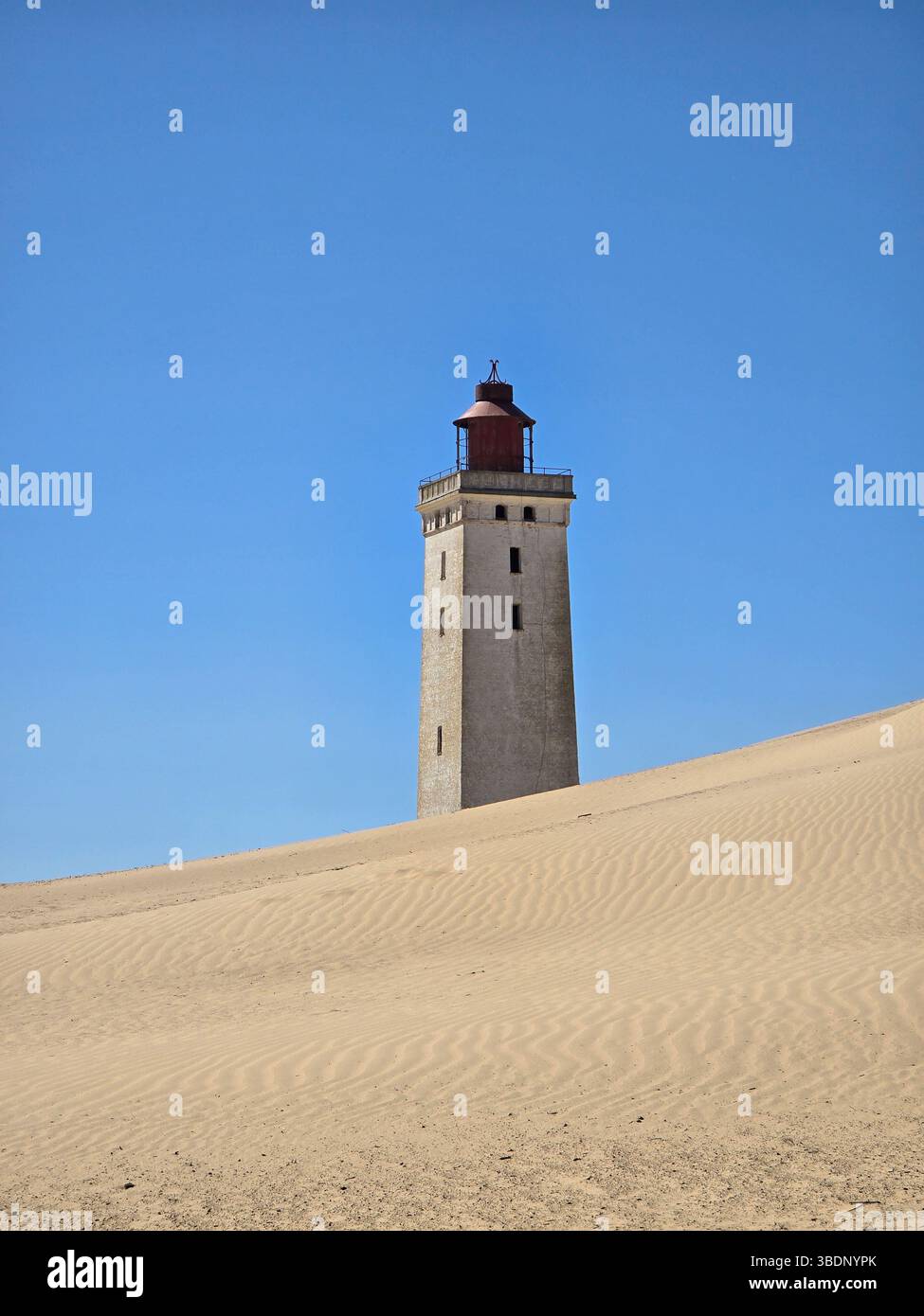Rubjerg Knude Lighthouse stands tall amidst the shifting sands of the ...