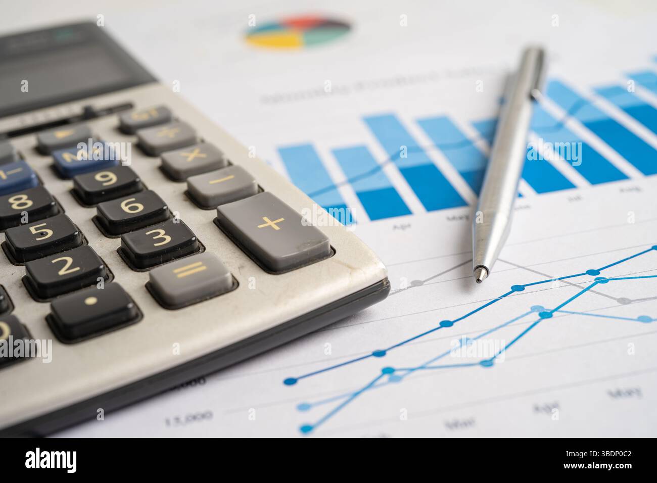 Calculator on chart and graph spreadsheet paper. Finance development ...