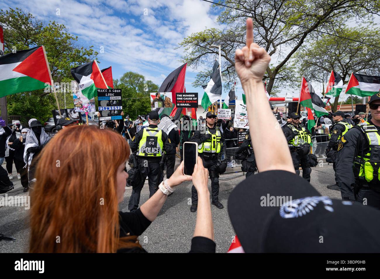 People gesture at pro-Palestinian protesters gathered along the route ...