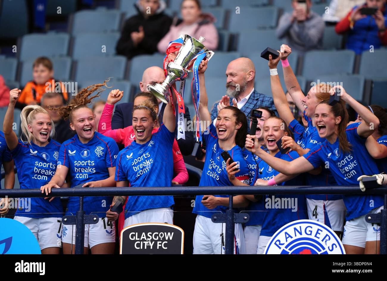 Rangers' Jane Ross (right) with the trophy, celebrates with team mates ...