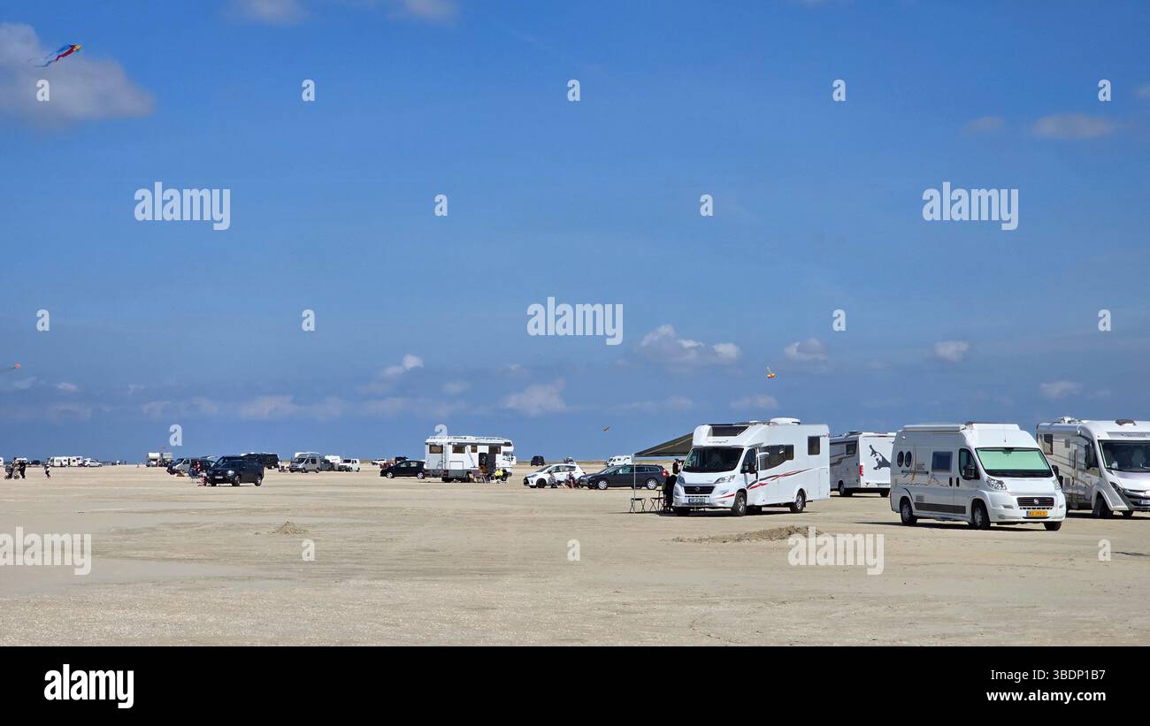Romo Denmark 12 May 2025, Campers and vehicles line a vast sandy beach ...