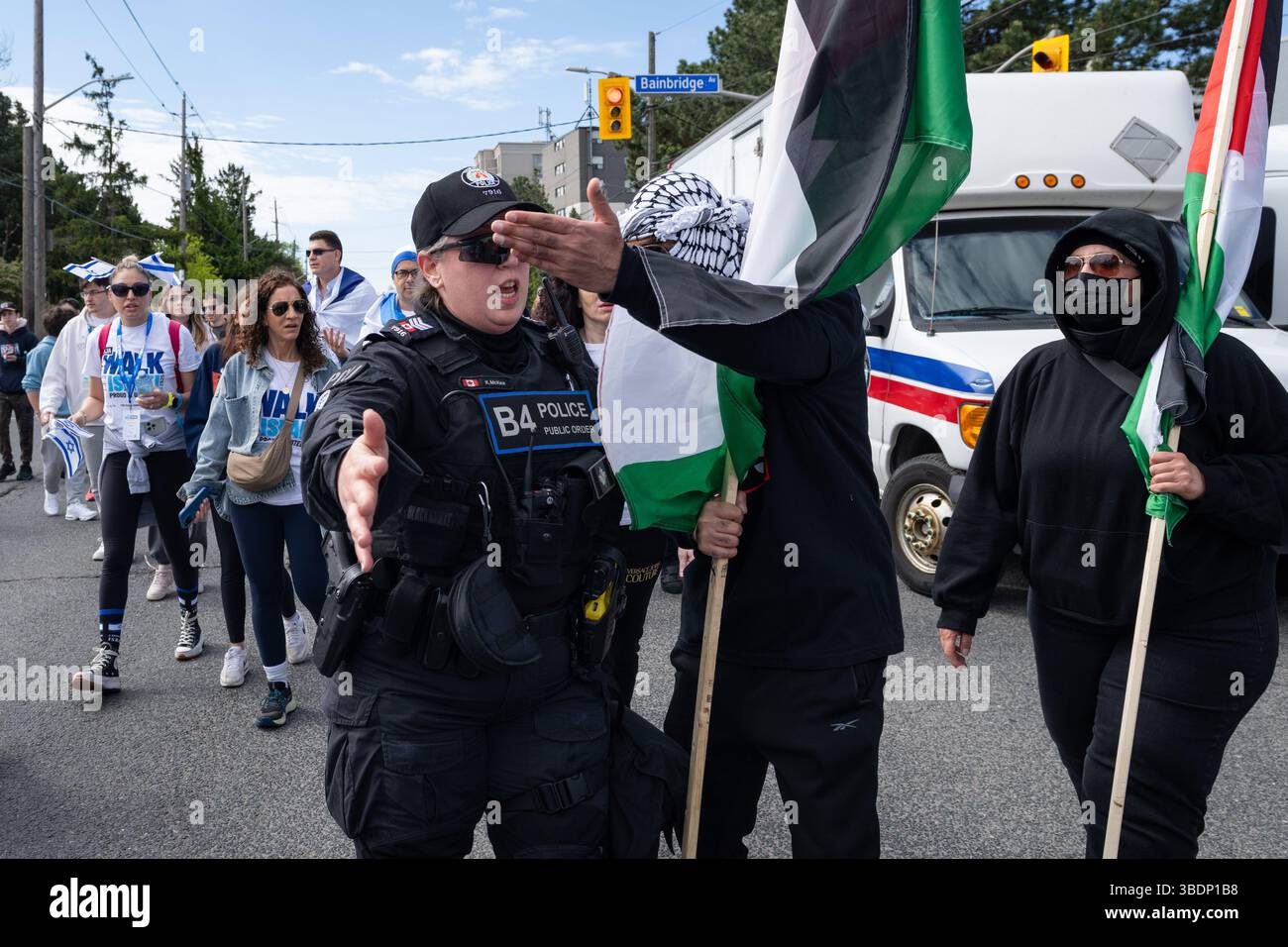 Pro-Palestinian protesters gather along the route of the United Jewish ...