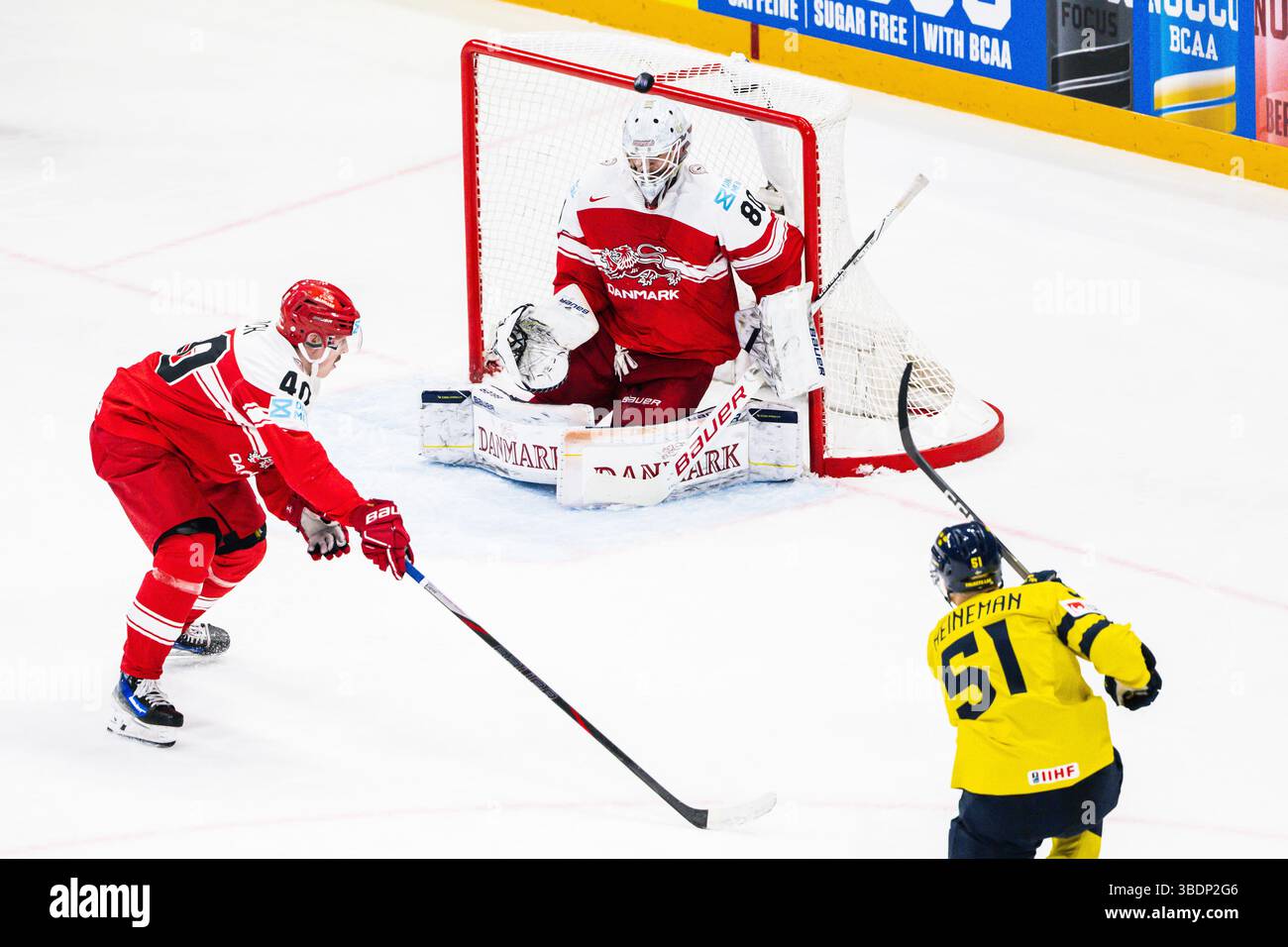 goaltender Frederik Dichow of, Denmark. , . and Emil Heineman of Sweden during the 2025 IIHF Ice ...