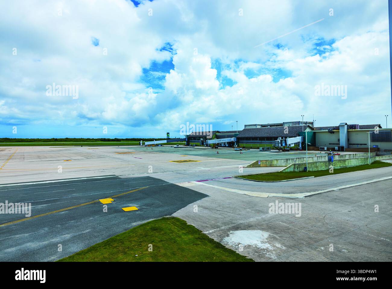 Airport runway and terminal building under cloudy sky with boarding ...