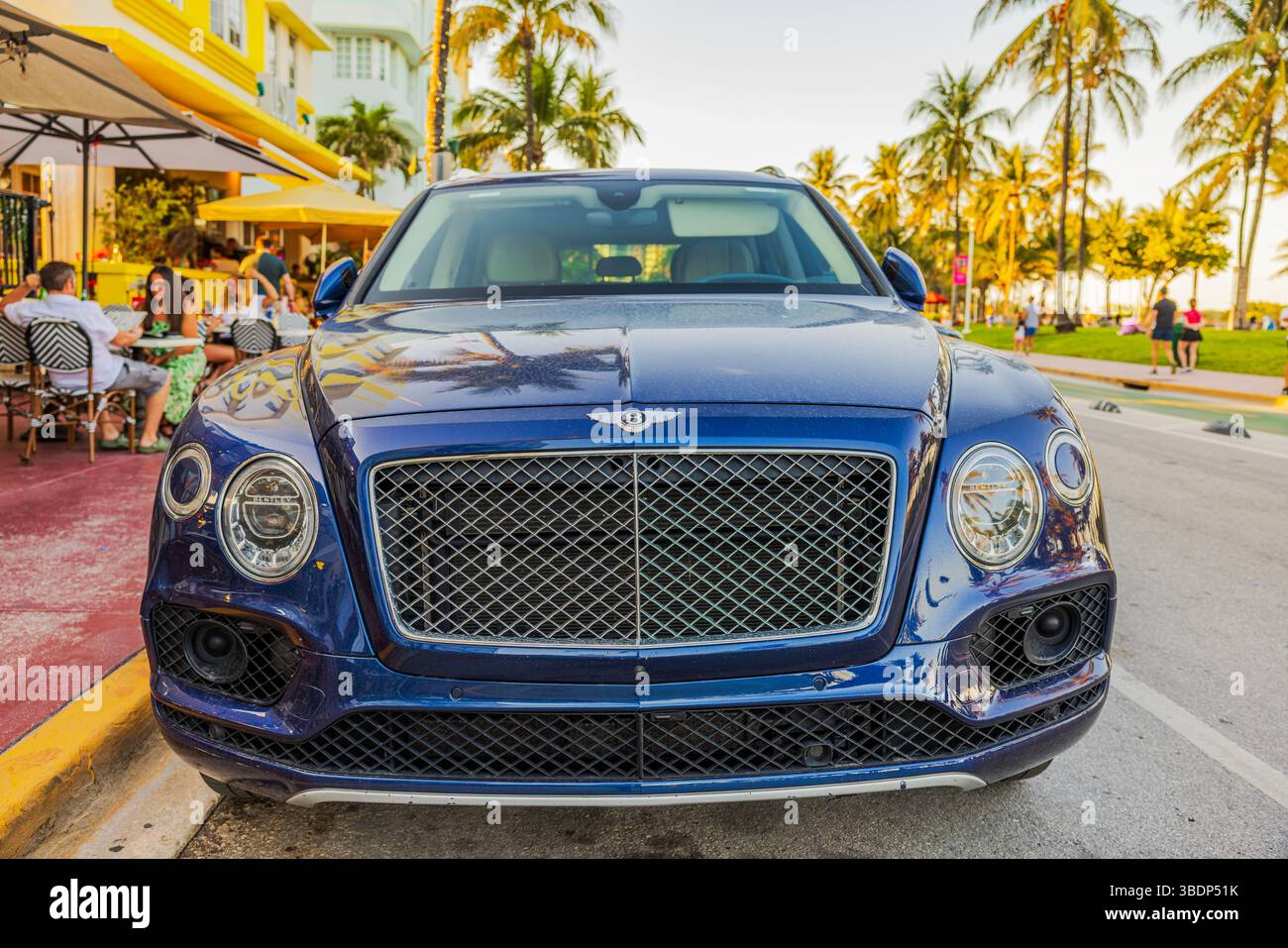 Front view of blue Bentley Bentayga SUV parked on Ocean Drive in Miami ...