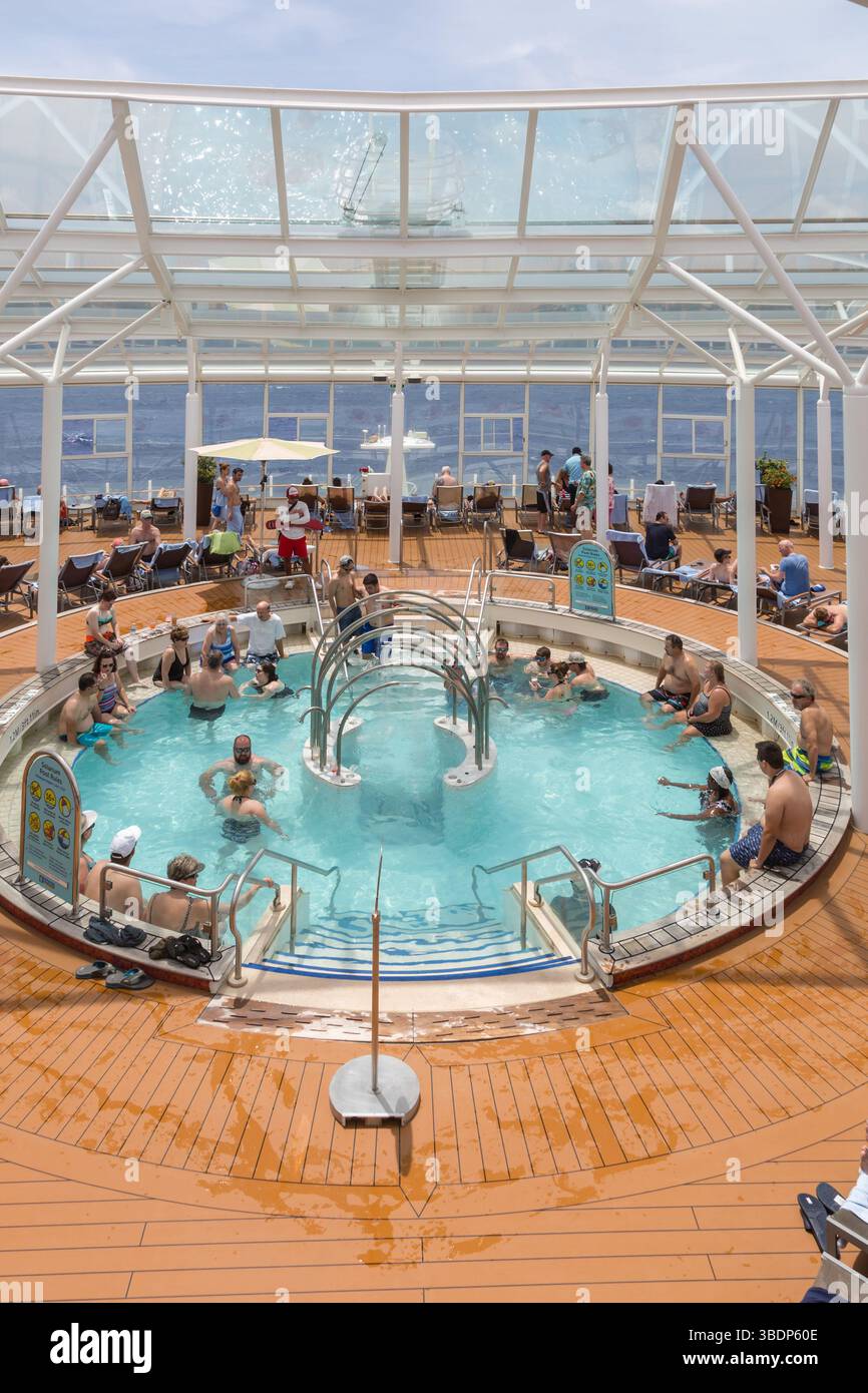 Adult cruise passengers enjoying the pool at the Solarium on the Royal ...