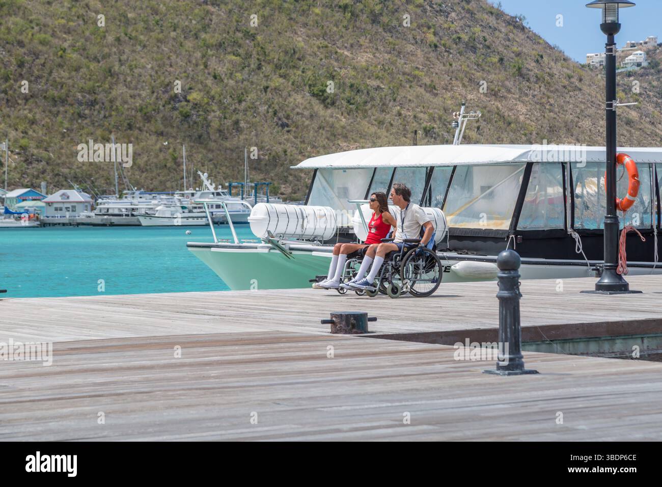 Hanidcapped couple in wheelchairs on the pier at the Captain Hodge ...
