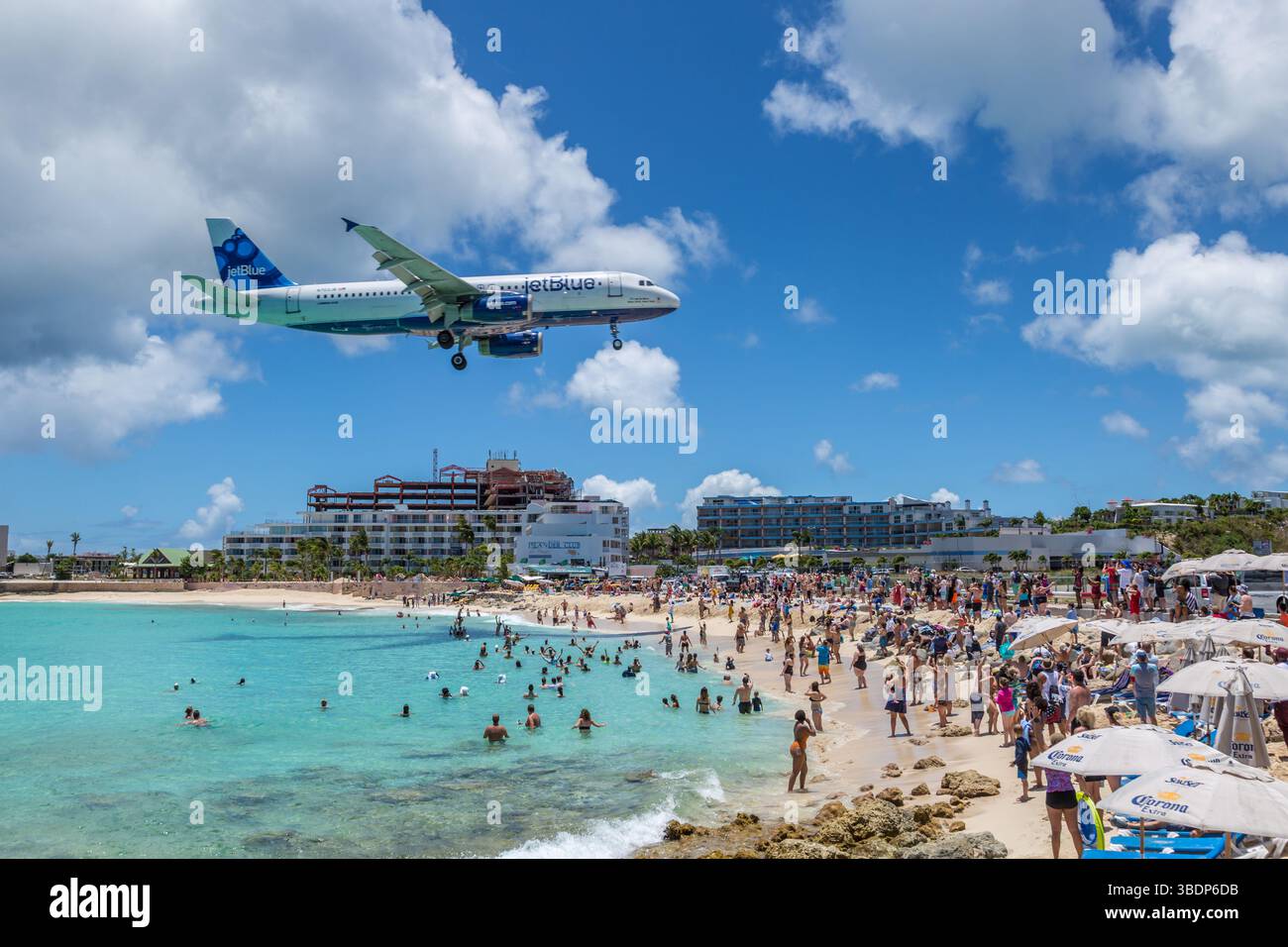 Commercial Jet Blue airliner flying low over Maho Beach on final ...