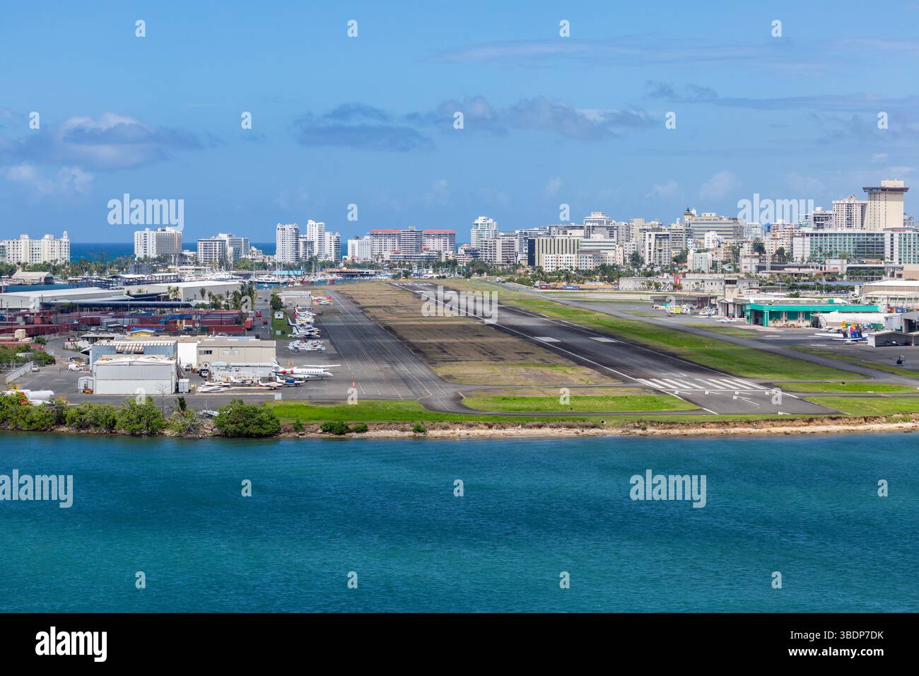 City skyline behind the Fernando Luis Ribas Dominicci airport runway in ...