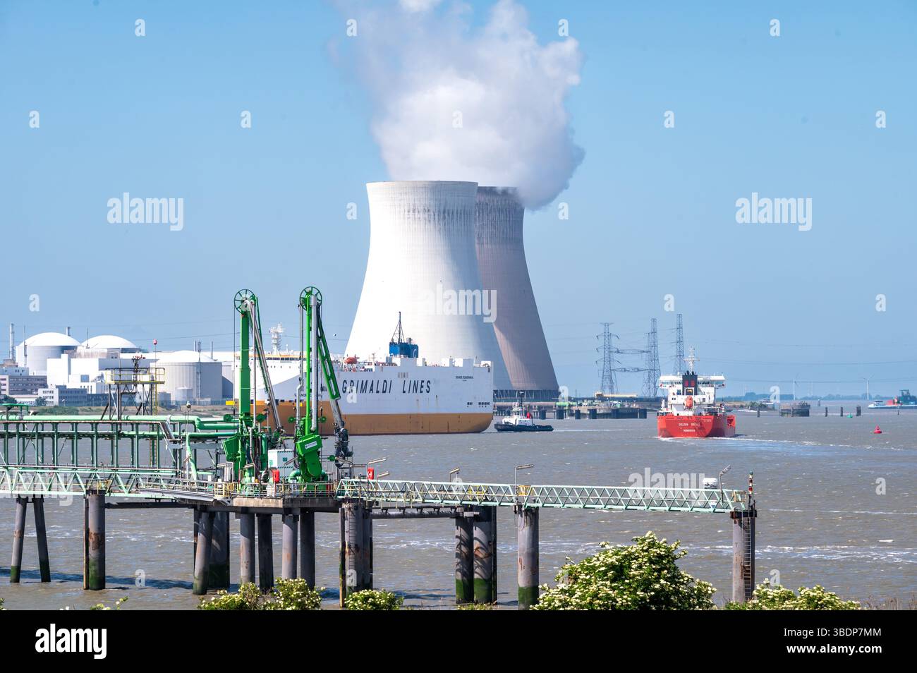 Cooling towers of Doel and cargo container ships at the river Scheldt ...