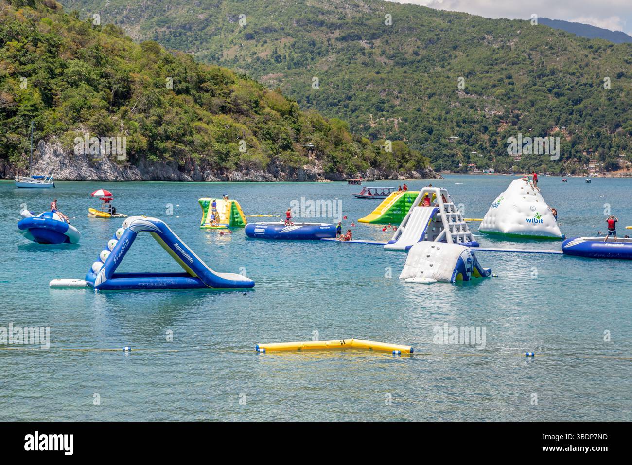 Cruise passengers playing on floating inflatable waterpark on Royal ...