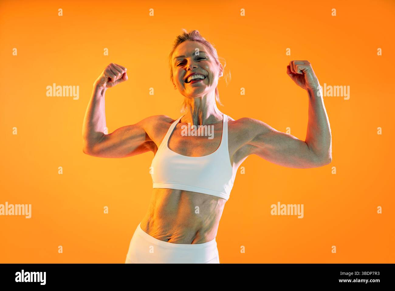 Mature woman flexing biceps hi-res stock photography and images - Alamy
