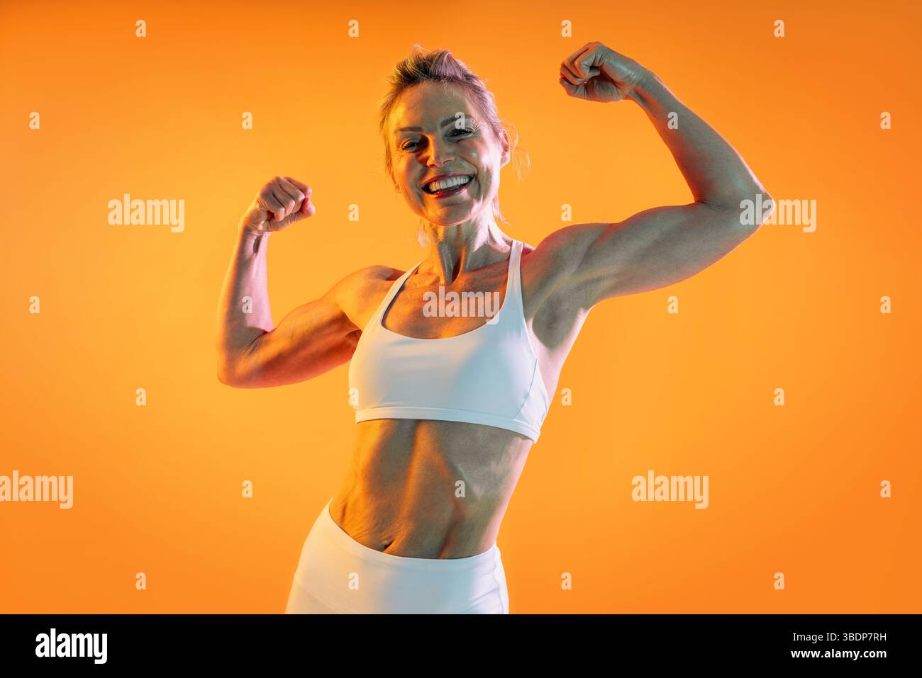 Mature woman flexing biceps hi-res stock photography and images - Alamy