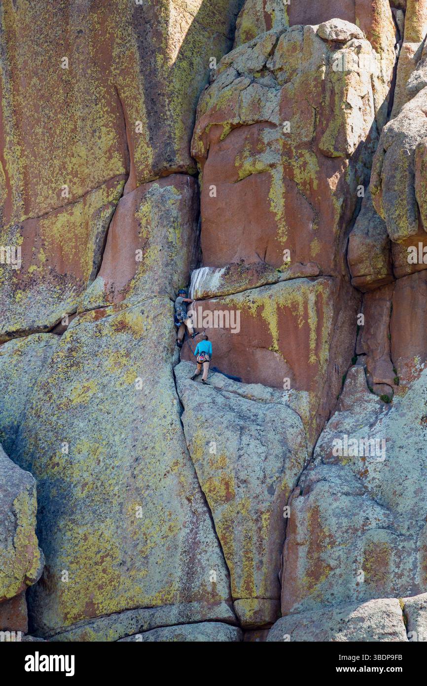 Man and woman rock climbing in the Vedauwoo Recreation Area of Medicine ...