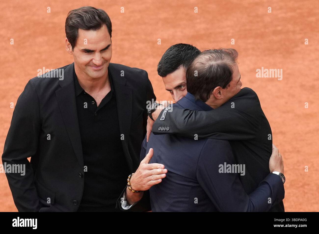 Rafa Nadal, second right, is hugged by Novak Djokovic as Roger Federer ...