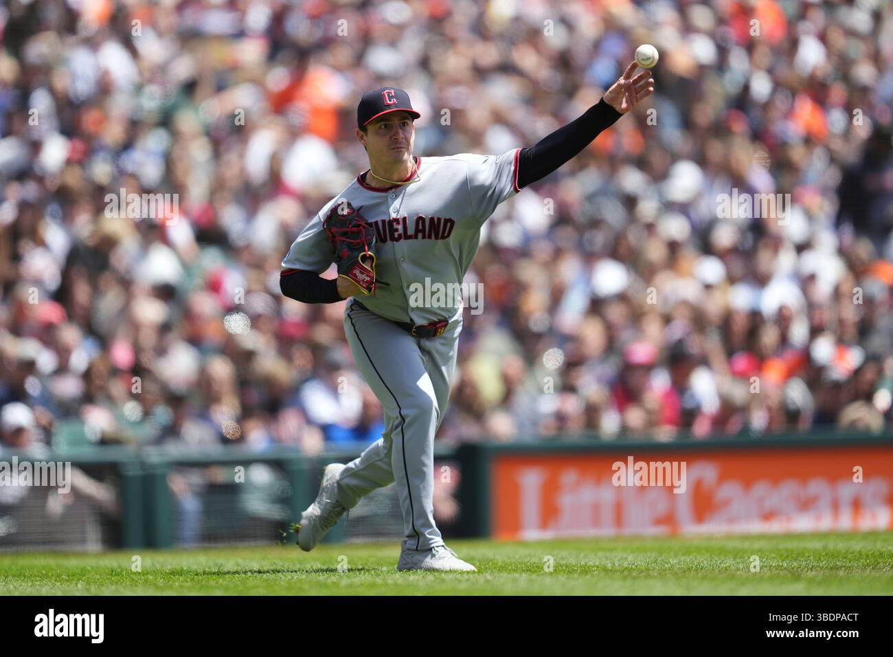 Cleveland Guardians pitcher Logan Allen throws errantly to first base ...