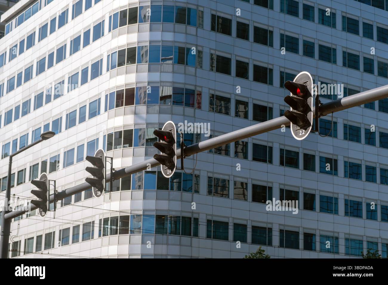 Red traffic light for cars, modern architecture high rise office ...