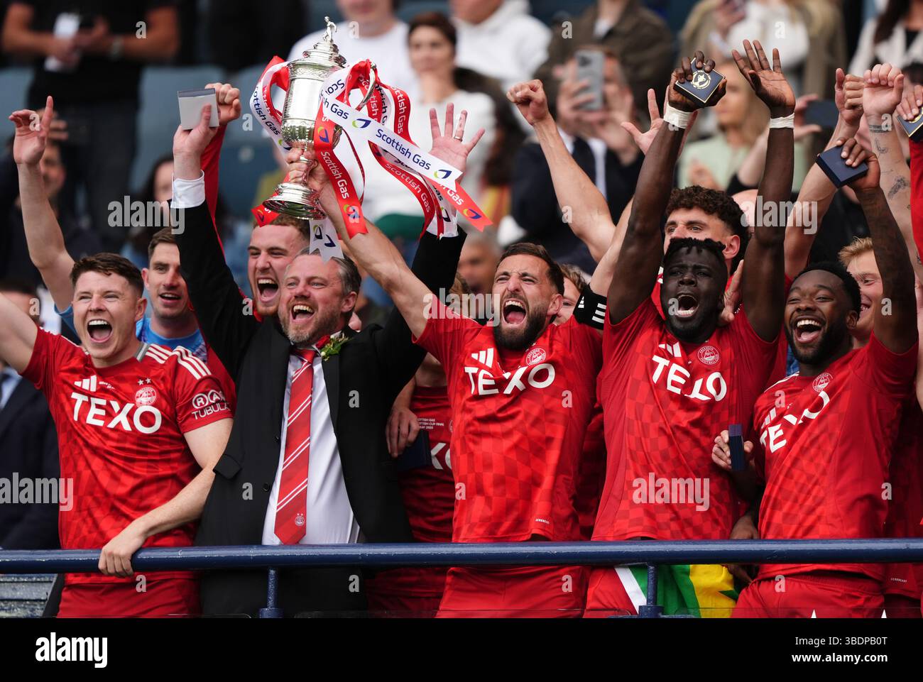 Aberdeen's Graeme Shinnie lifts the trophy with manager Jimmy Thelin ...