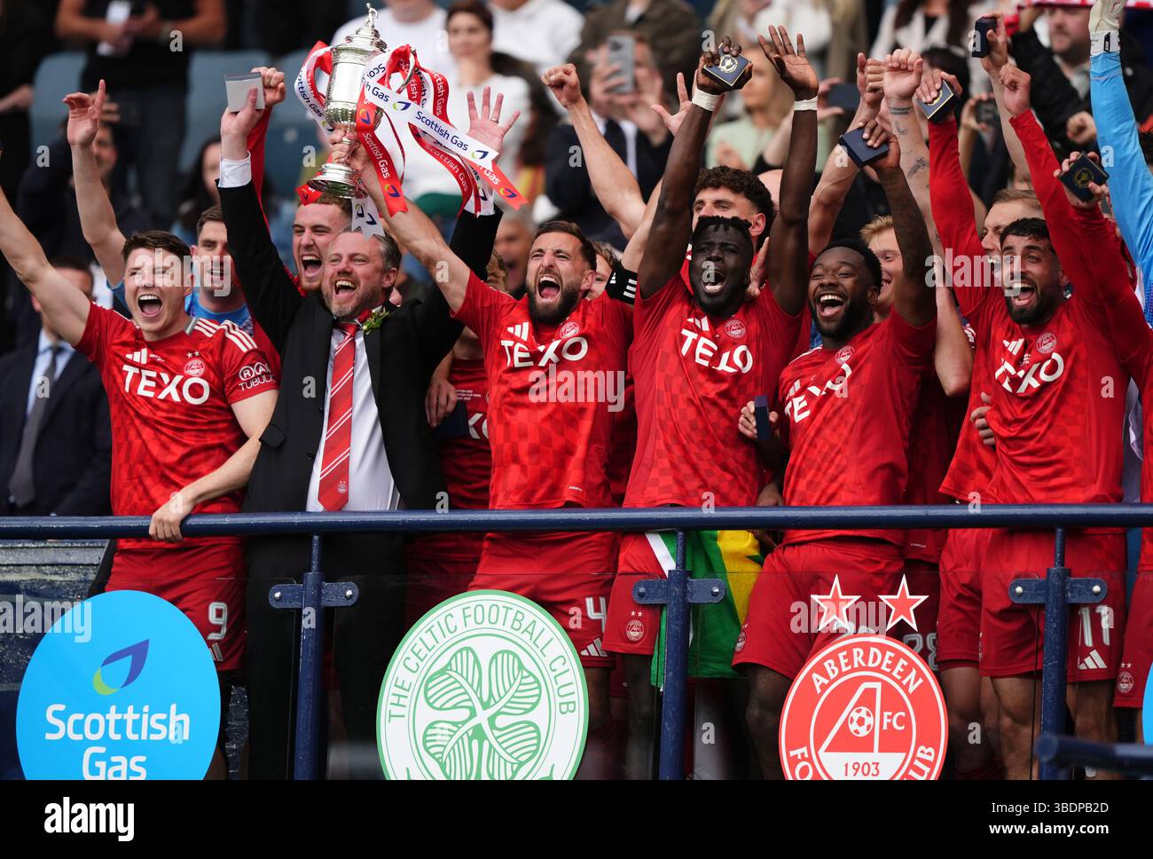 Aberdeen's Graeme Shinnie lifts the trophy with manager Jimmy Thelin ...