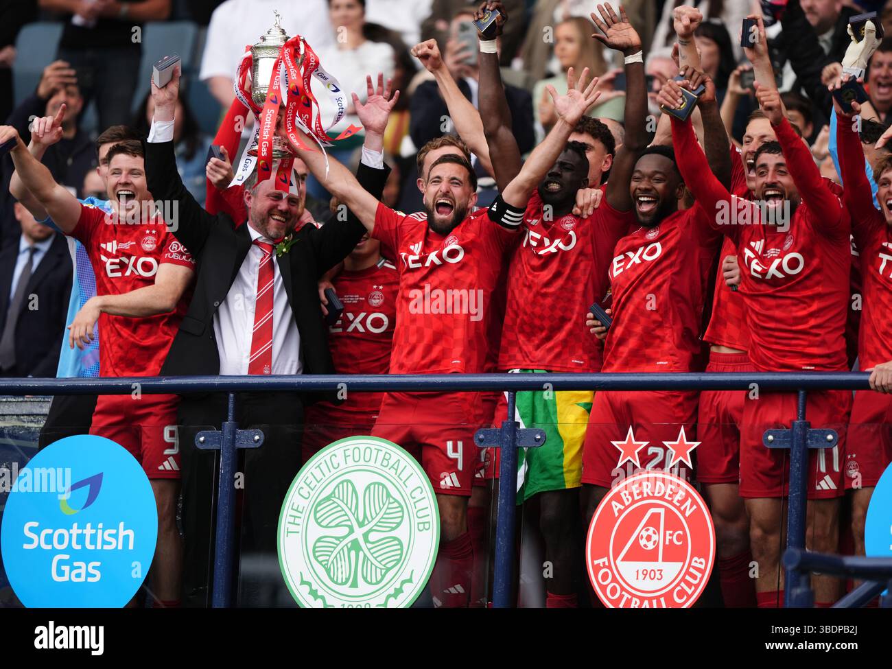 Aberdeen's Graeme Shinnie lifts the trophy with manager Jimmy Thelin ...