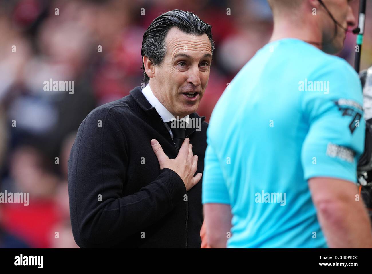 Aston Villa manager Unai Emery (left) speaks to referee Thomas Bramall ...