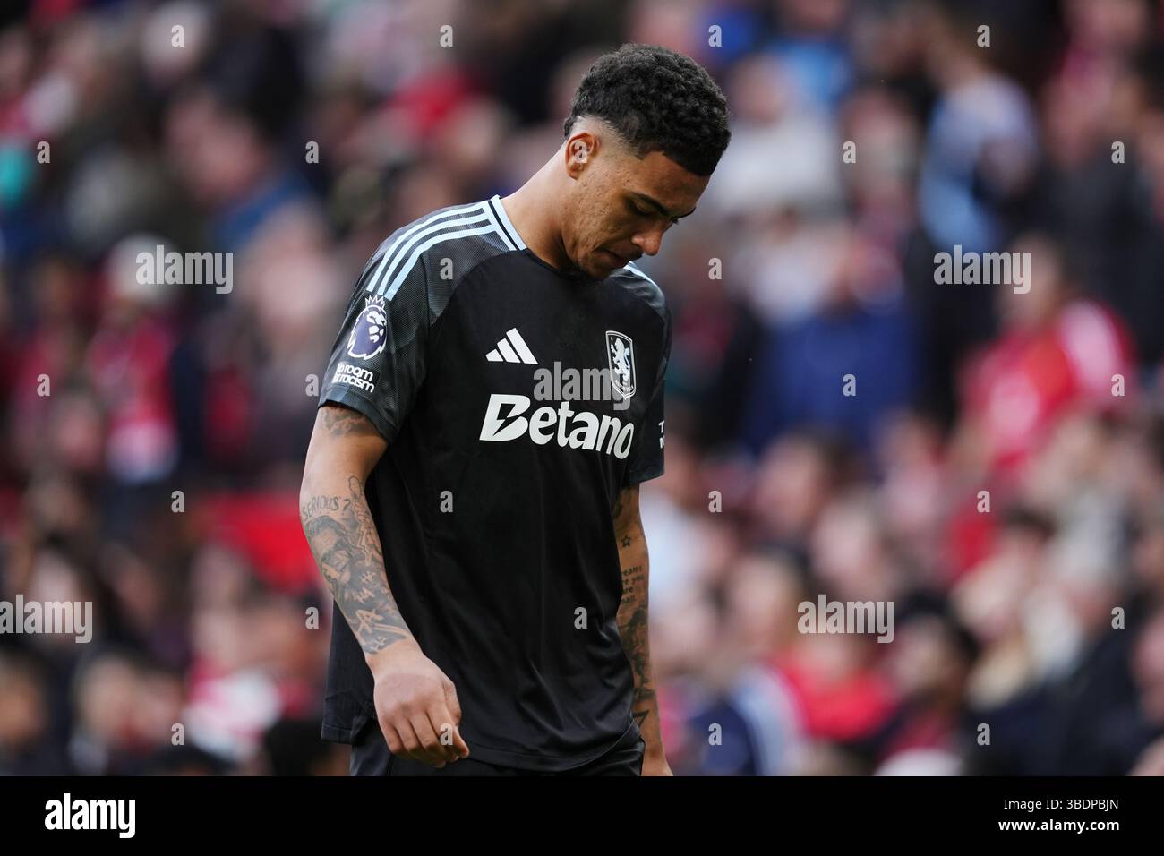 Aston Villa's Morgan Rogers stands dejected after the Premier League ...