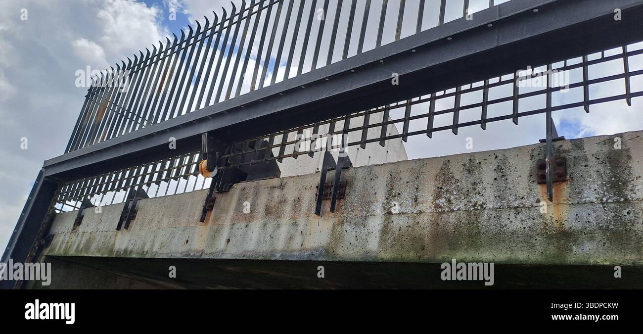 Metal railing and gate system controlling water flow in a flood control ...