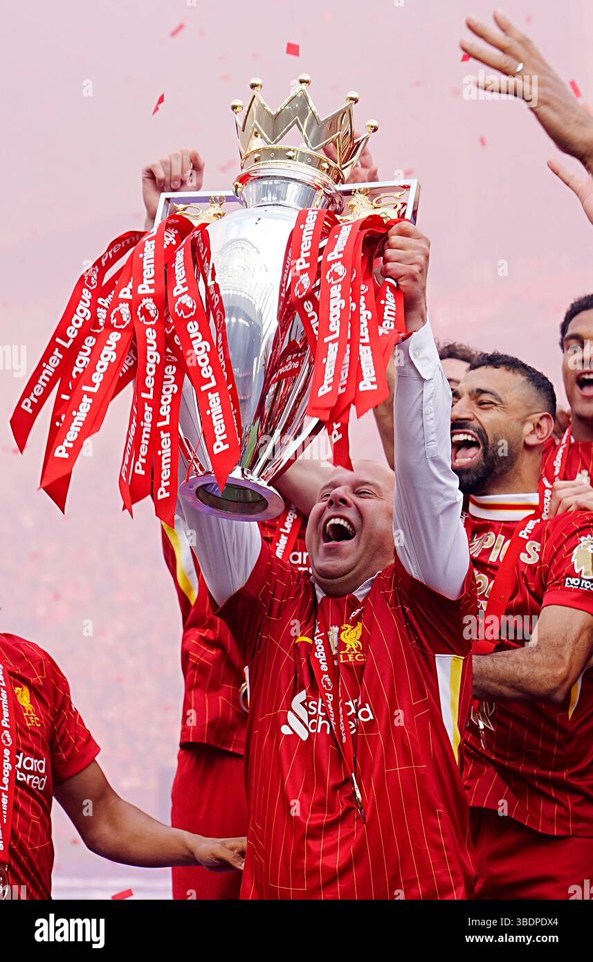 Liverpool manager Arne Slot lifts the Premier League trophy with the ...