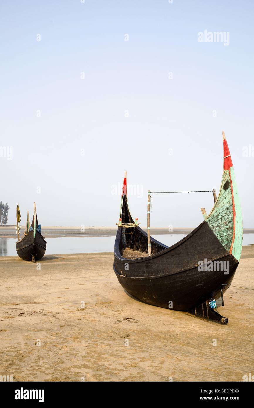Traditional wooden fishing boats with curved prow known as shampan rest ...