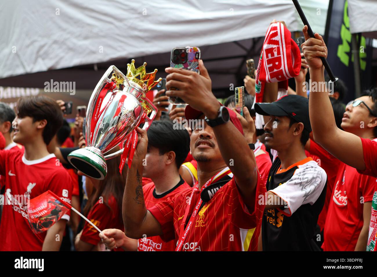 A general view of the atmosphere Fans Liverpool pose with a replica ...