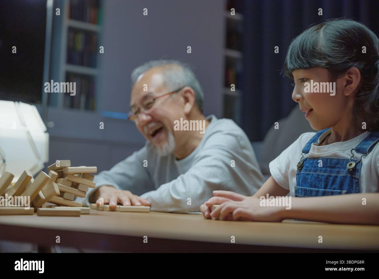 Asian family enjoy playing toy block with little daughter together in home living room Stock ...