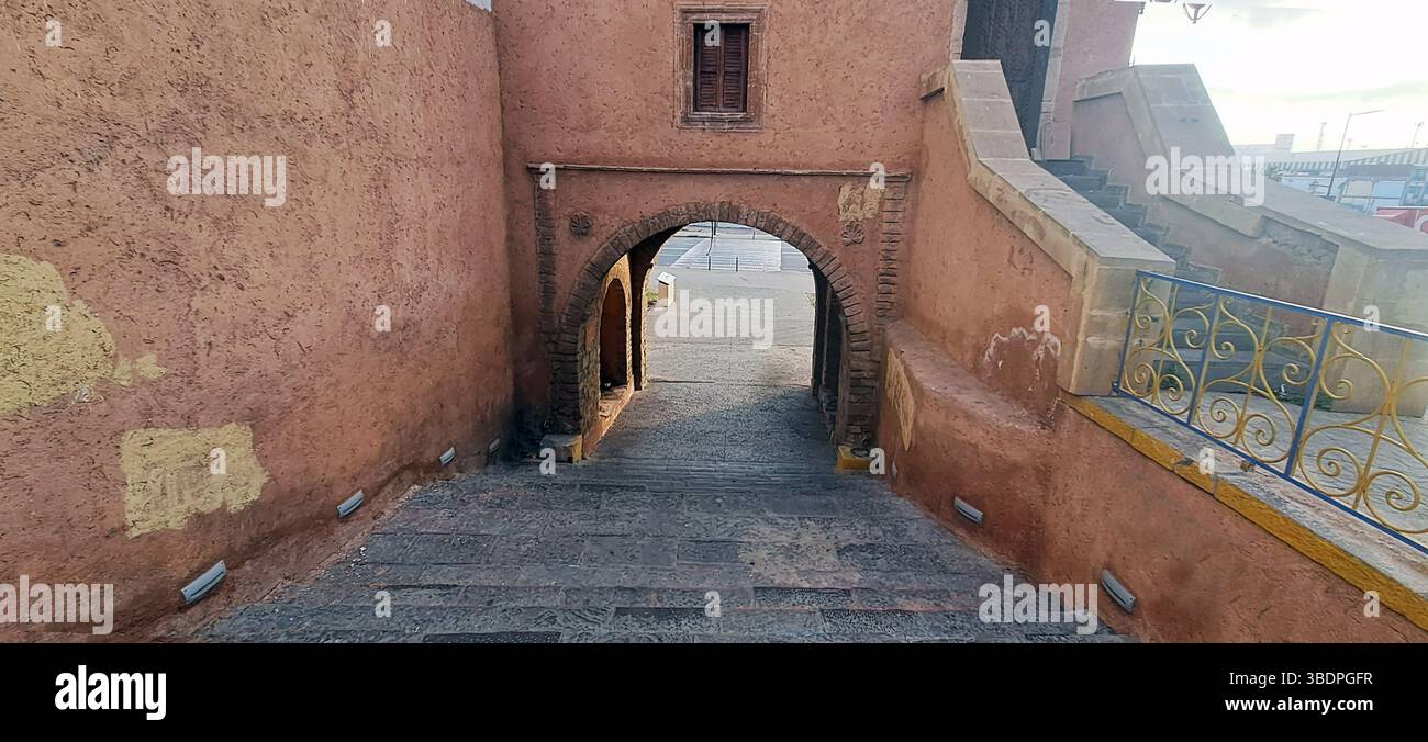 Stone steps leading down through a traditional moroccan archway ...