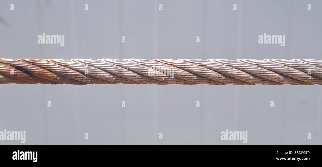 Close-up of a rusty steel cable showing signs of wear and tear ...