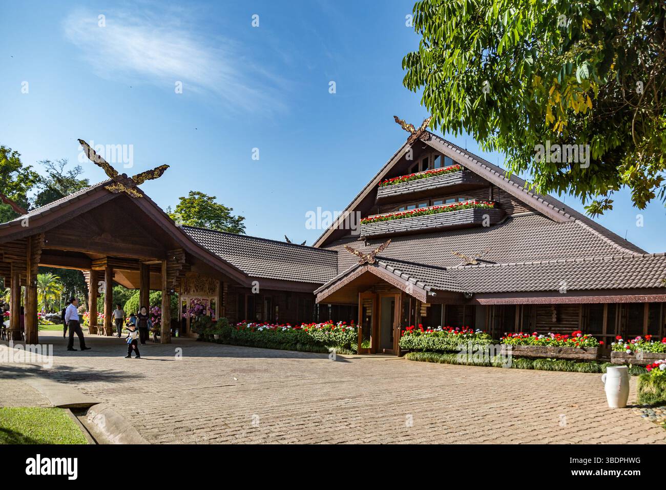 Ornate trees and lush flower gardens enhance the Lanna and Swiss ...