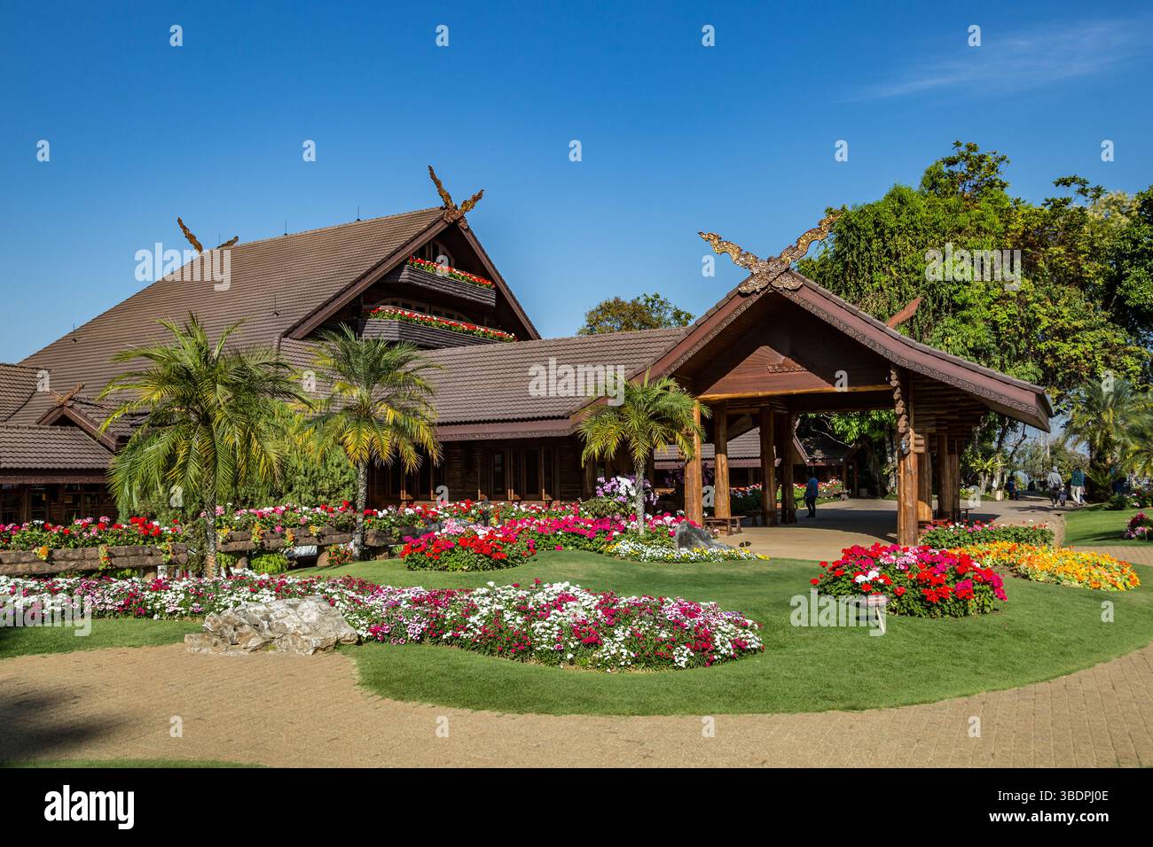 Ornate trees and lush flower gardens enhance the Lanna and Swiss ...