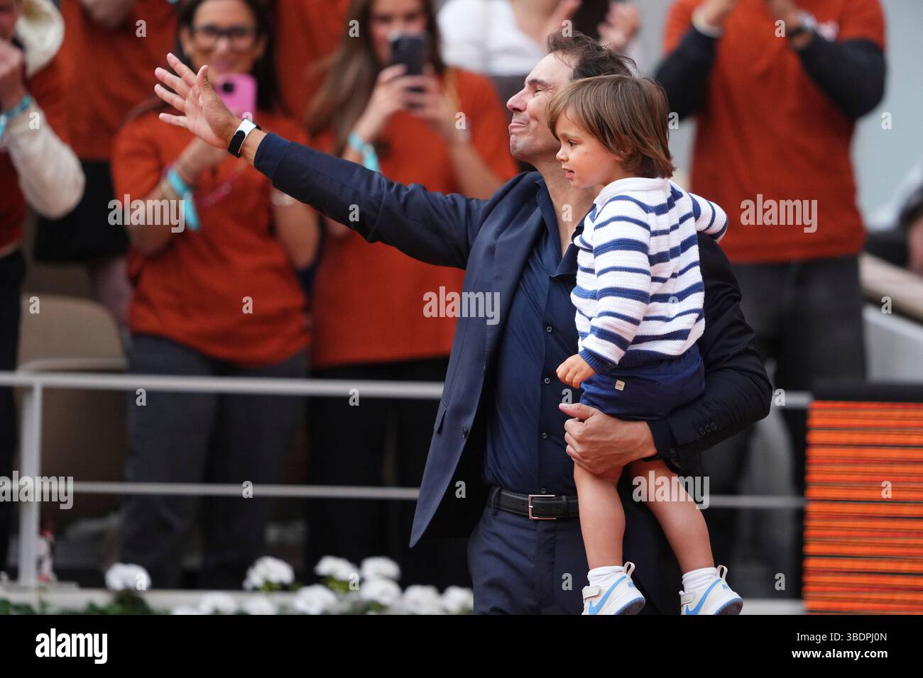 Rafa Nadal holds his son Rafael Junior as he waves to the crowd during ...