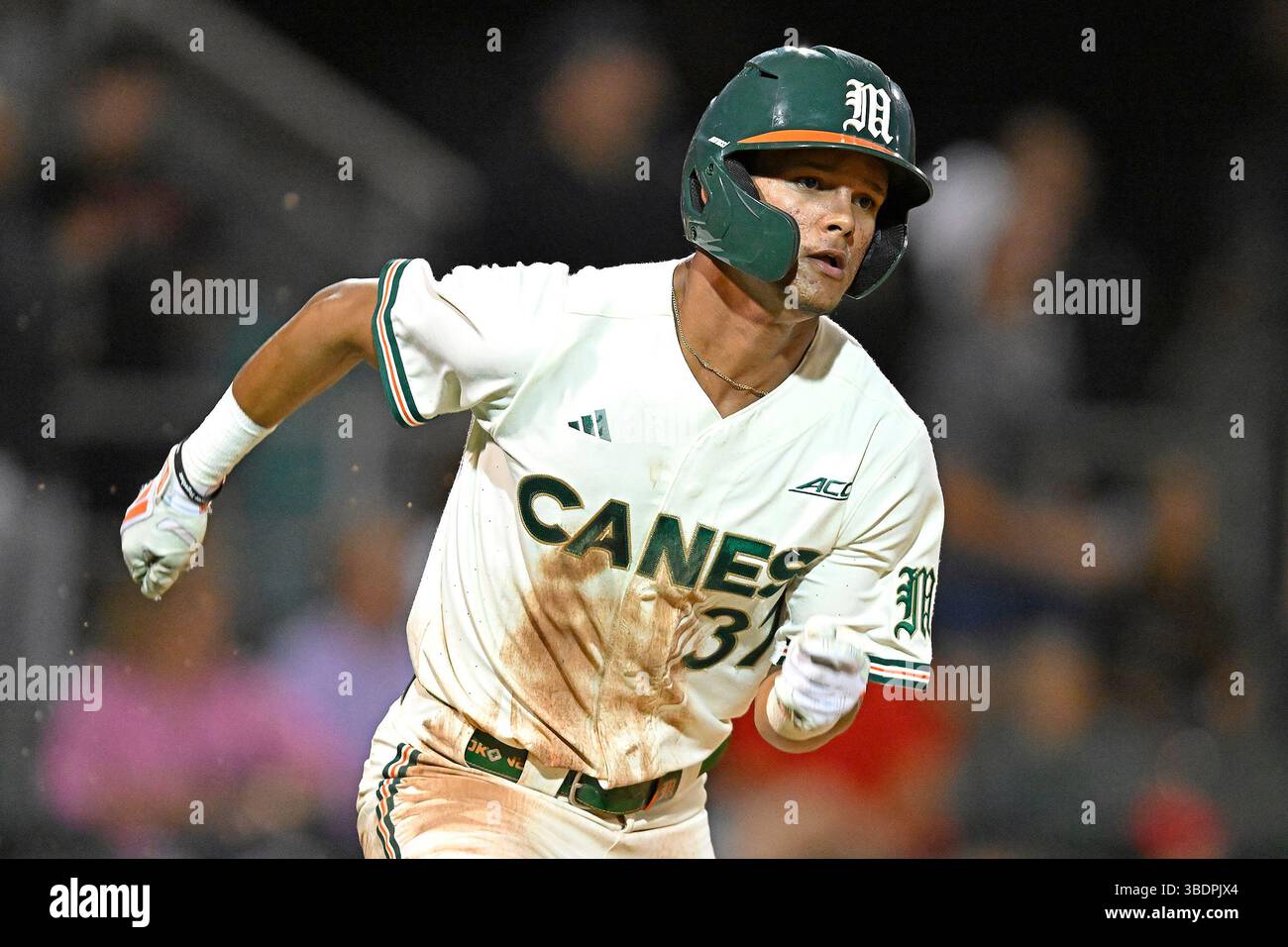 CORAL GABLES, FL - MAY 16: Miami outfielder Fabio Peralta (37) runs to ...