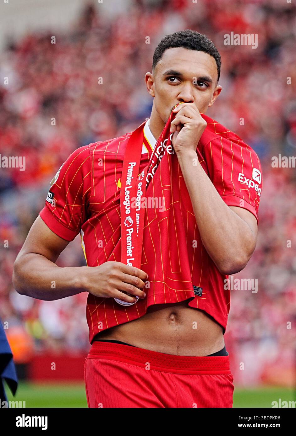 Liverpool's Trent Alexander-Arnold kisses the badge as he collects his ...