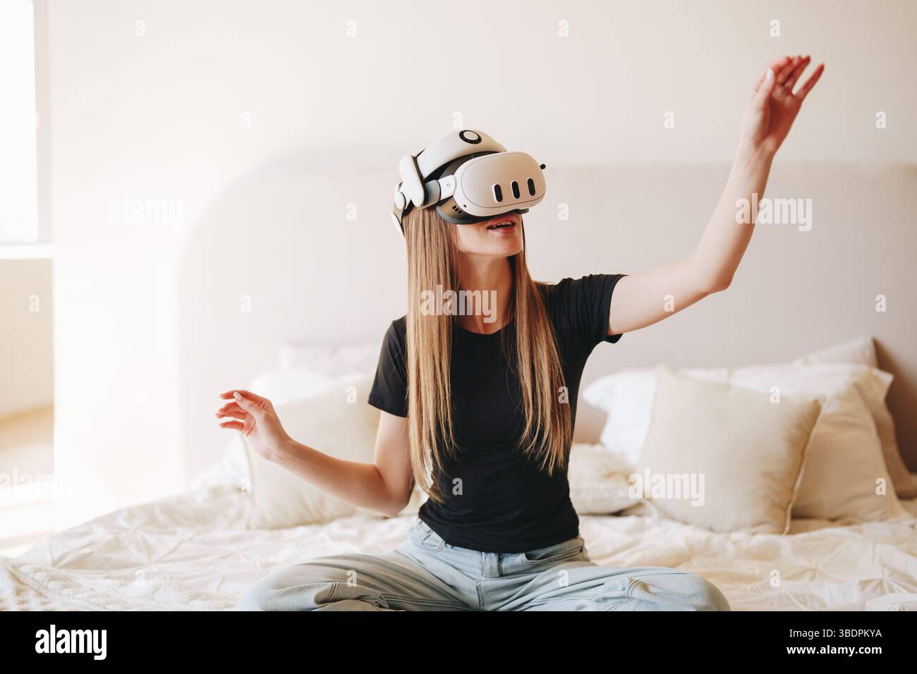 Young woman engages with virtual reality in a cozy bedroom setting ...