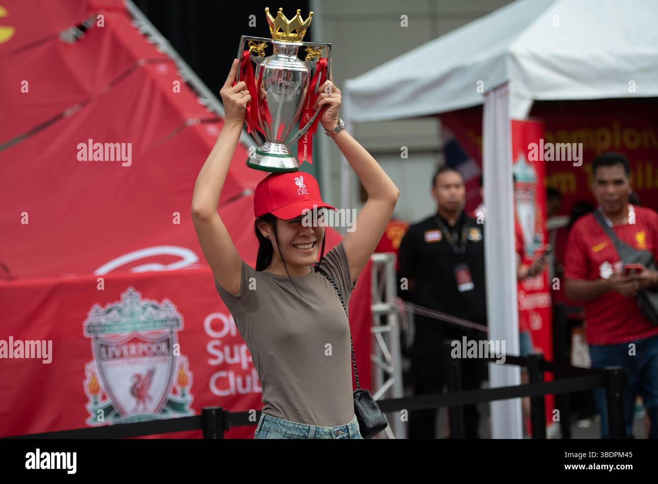 A general view of the atmosphere Fans Liverpool pose with a replica Premier League trophies, at ...