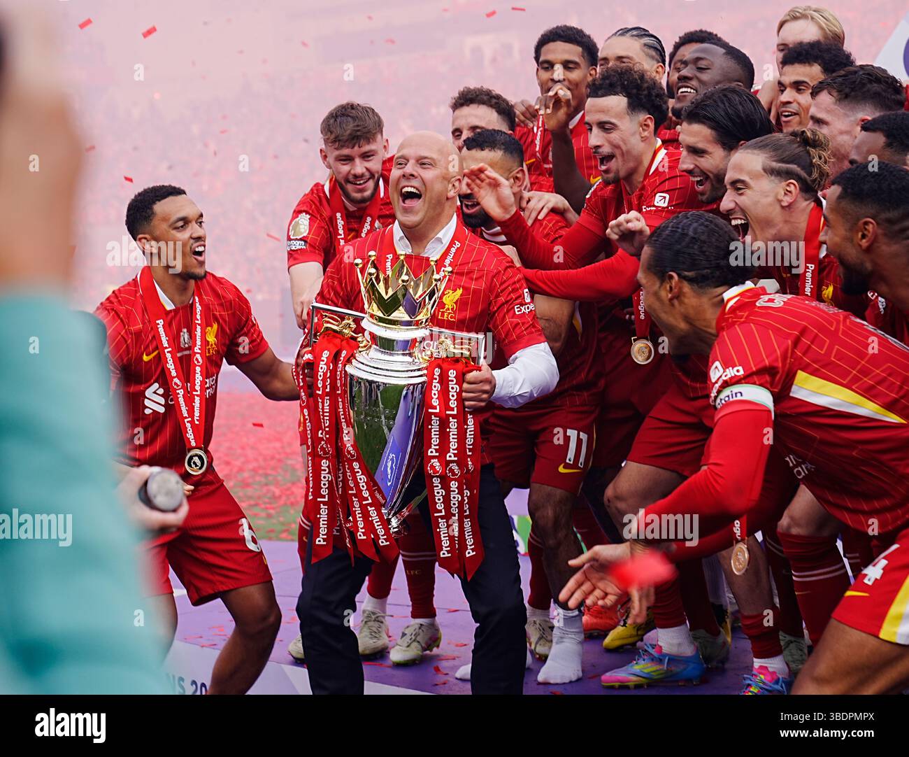 Liverpool manager Arne Slot lifts the Premier League trophy with the players after the Premier ...